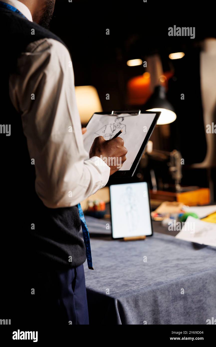 Meticulous fashion designer conceptualizing bespoke sartorial business ...