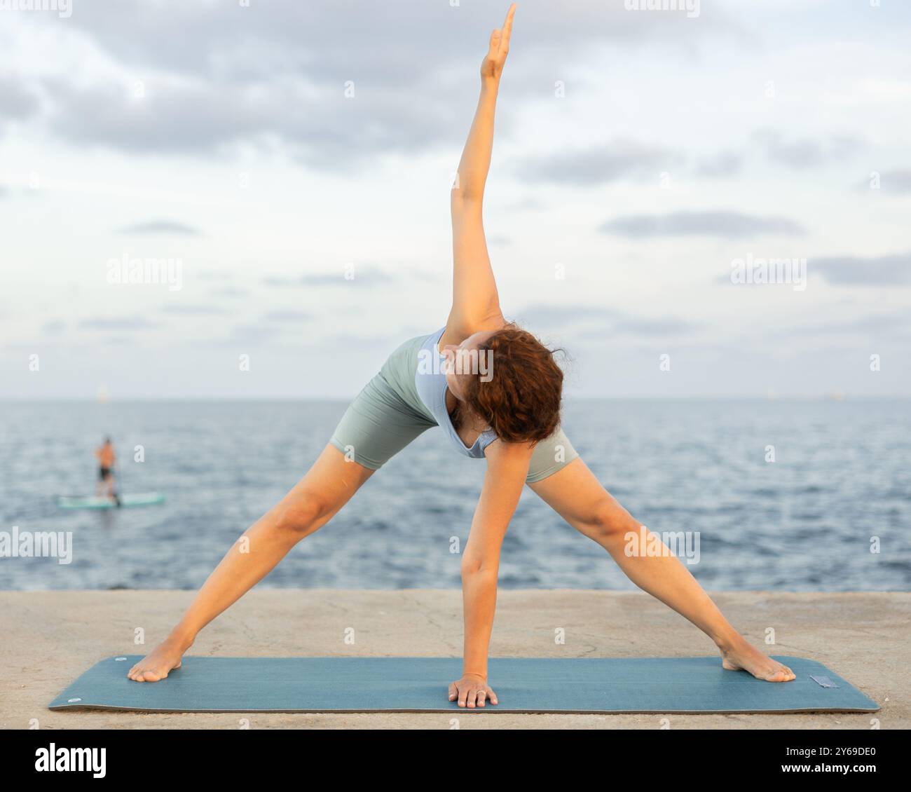 Yoga pose called pyramid performed by a woman on seashore Stock Photo ...