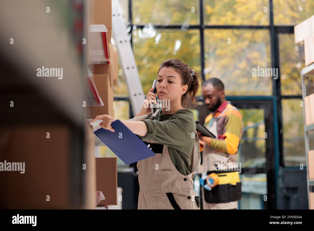 Employee talking at landline phone with remote supervisor, working at ...