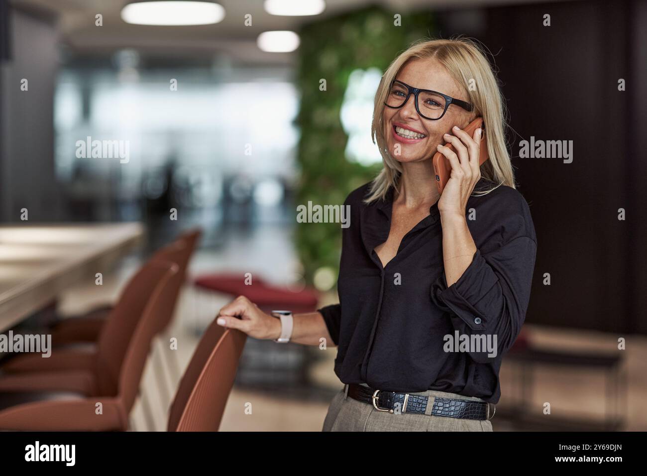 A Professional Woman Engaged in an Important Business Call Within a ...