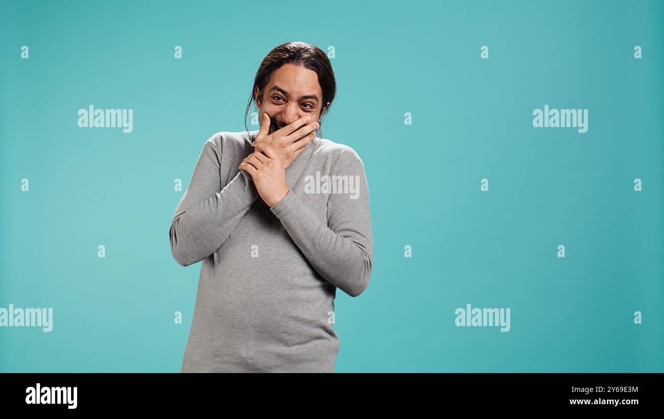 Portrait of cheerful man laughing hard, amused by funny joke, studio ...