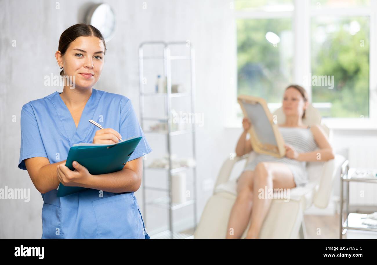 After cosmetic procedure, woman doctor interviews client and enters ...