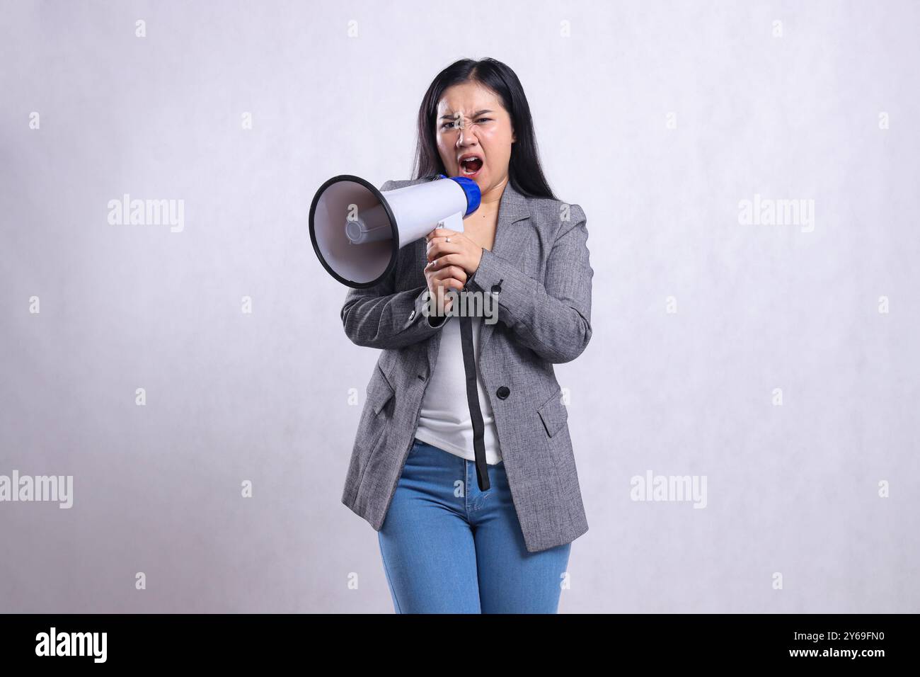 formal beautiful young girl screaming angry both hands holding ...