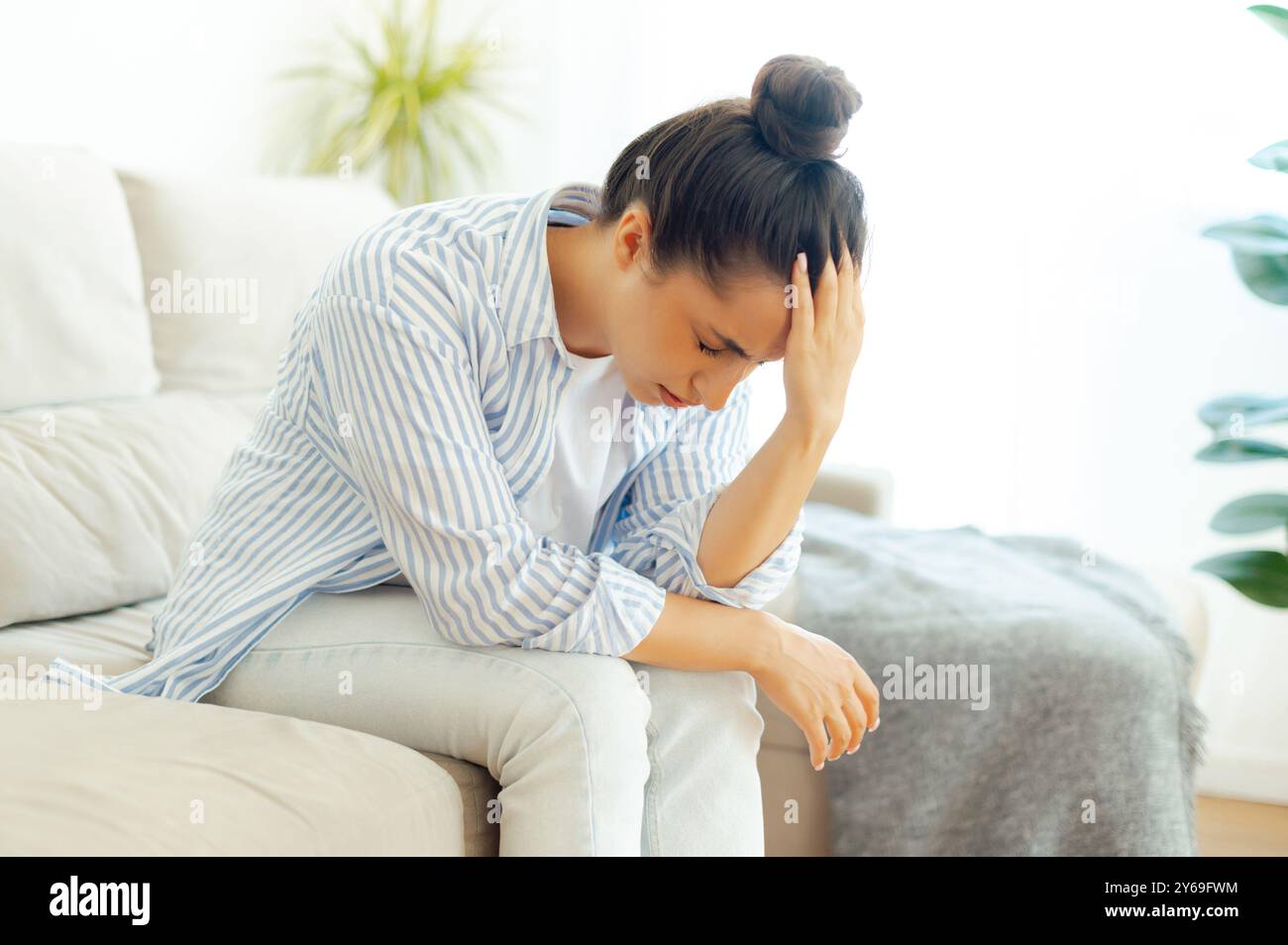 Frustrated sad caucasian young woman in casual clothes, sitting on a ...