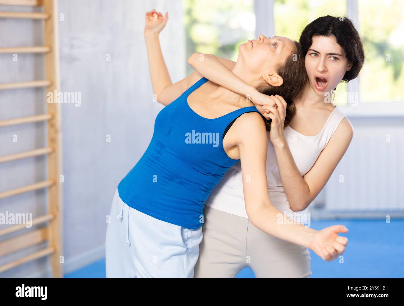 Woman makes a choke hold in self defense trainin Stock Photo - Alamy