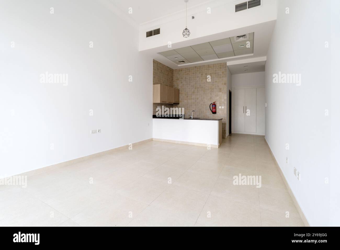 empty small room, kitchen, wall cabinet,glossy tiled floors and white ...