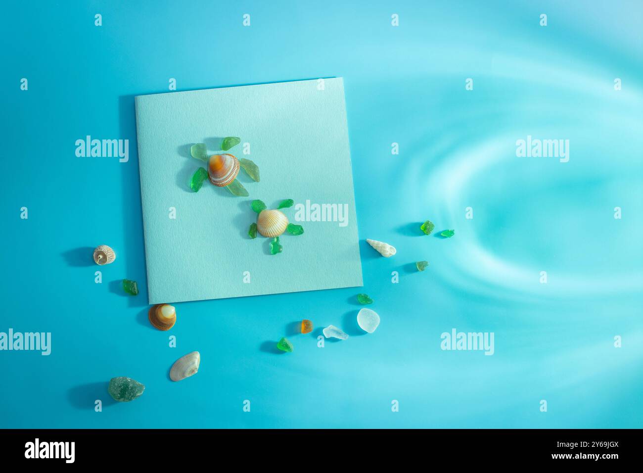 Turtle design using seashells and glass on blue sea background. Large ...