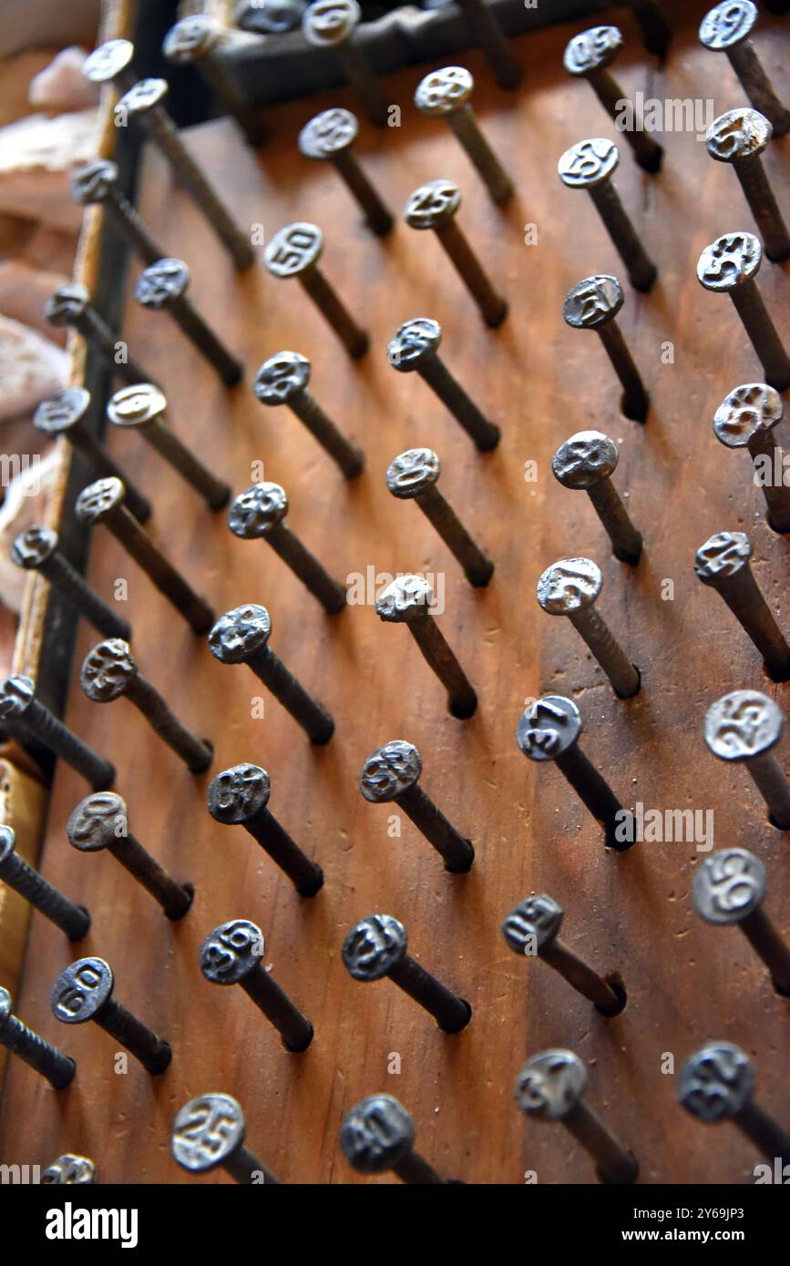 Board holds collection of "railroad date nails", used in the railroad ...
