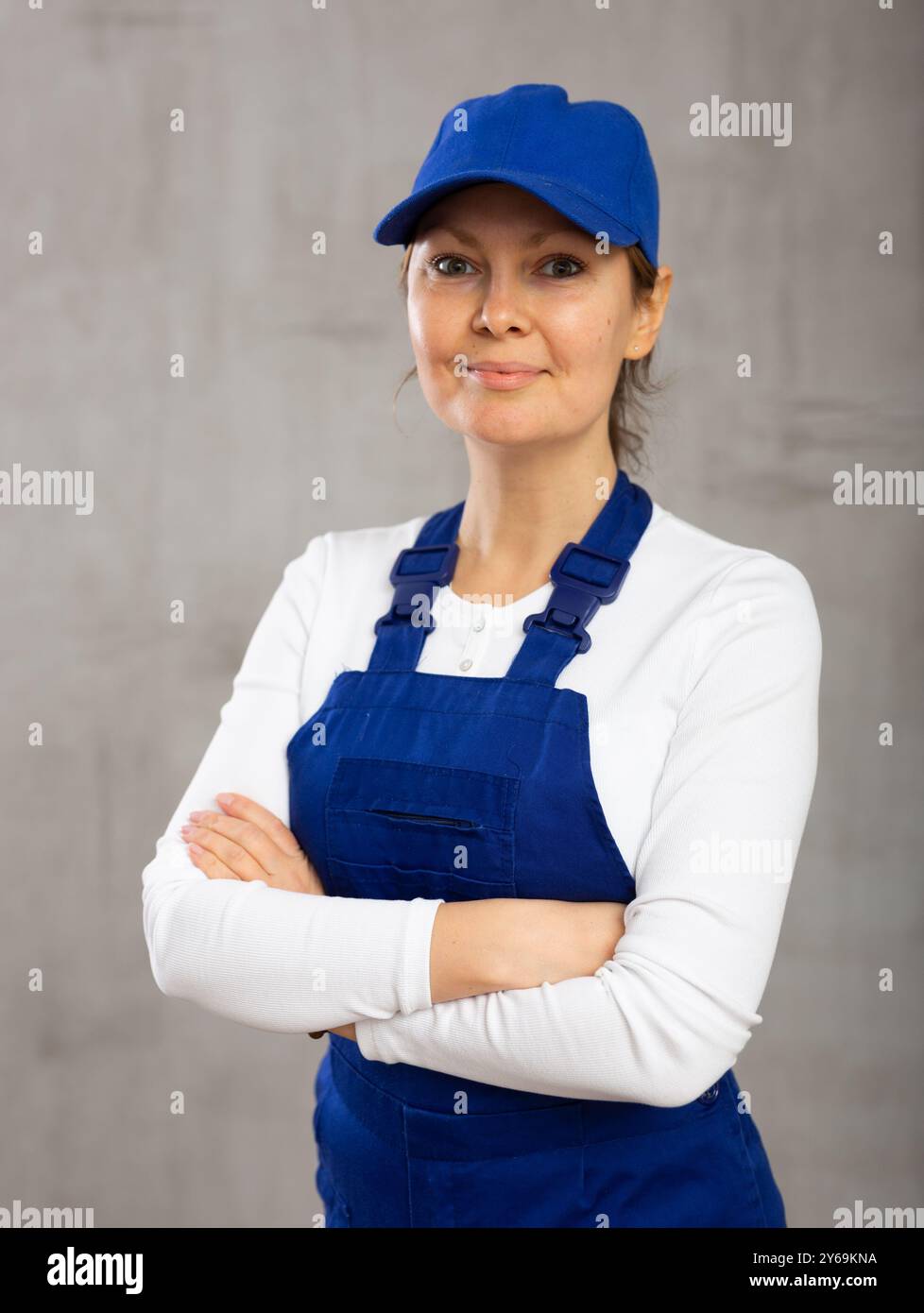 Cheerful female worker in uniform with wide grin on her face Stock ...