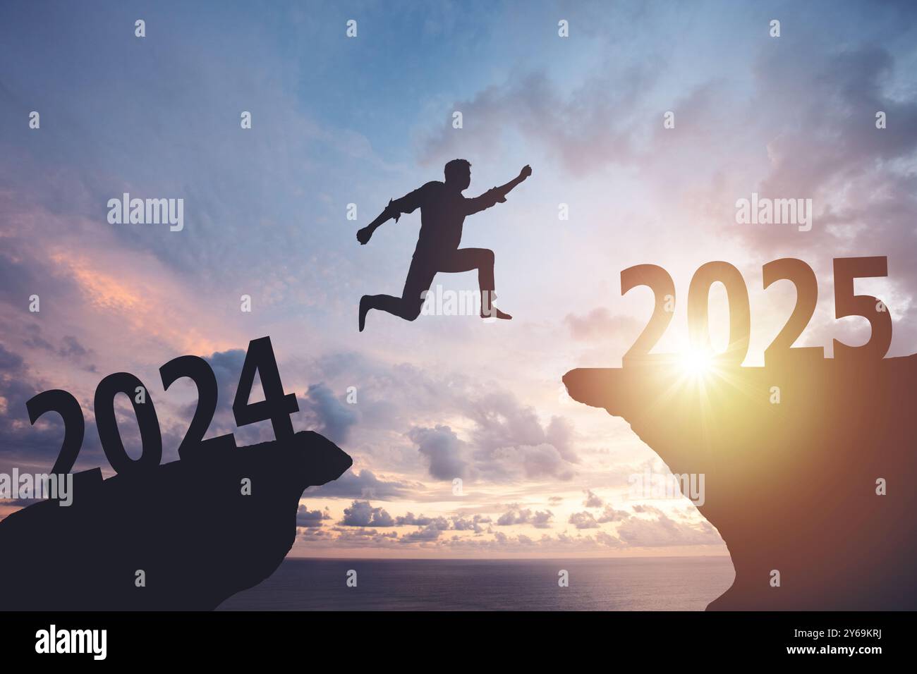 Silhouette of a man jumping from cliff to cliff Stock Photo - Alamy