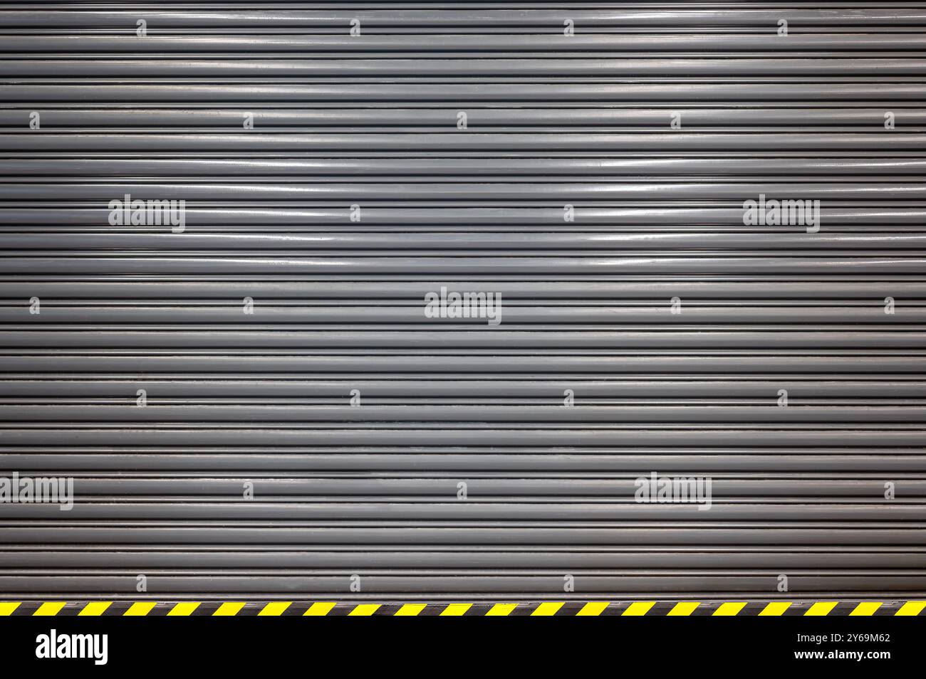 stainless steel roll-up door, horizontal slats. caution stripe bottom ...