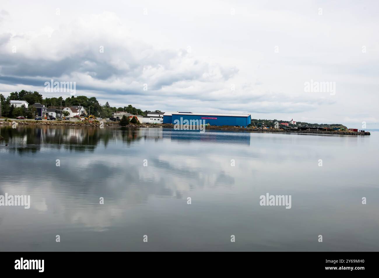 Calm water and Moor Frost blue building on Water Street in Bay Roberts ...