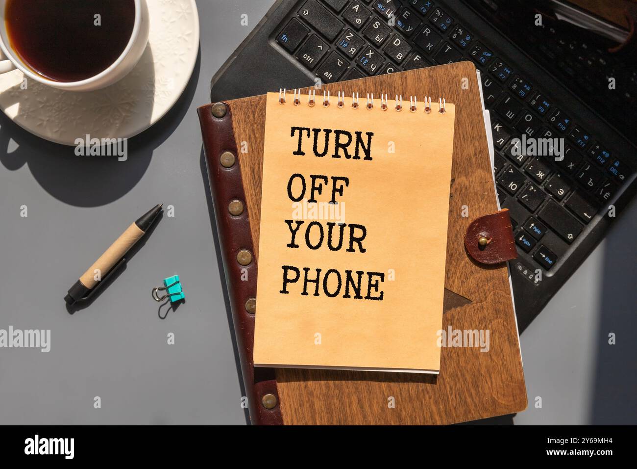 Business man pointing the text Turn Off Your Phone Stock Photo - Alamy