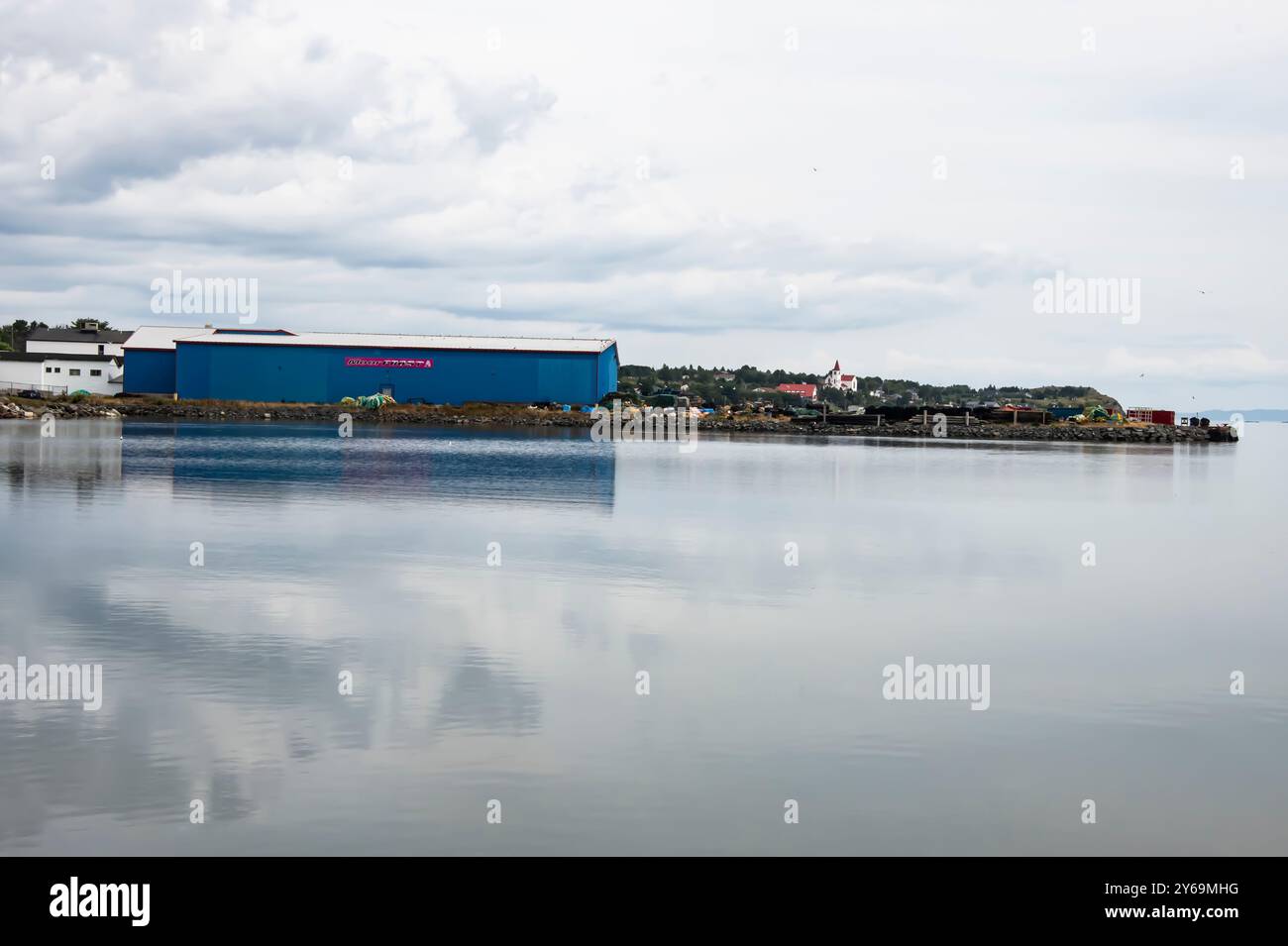 Calm water and Moor Frost blue building on Water Street in Bay Roberts ...