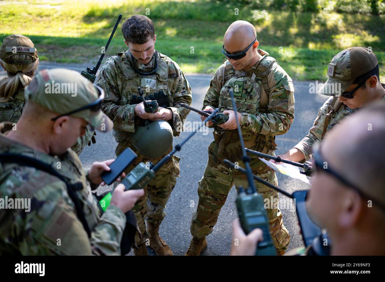 U.S. Air Force Airmen configure radios before a defensive fighting ...