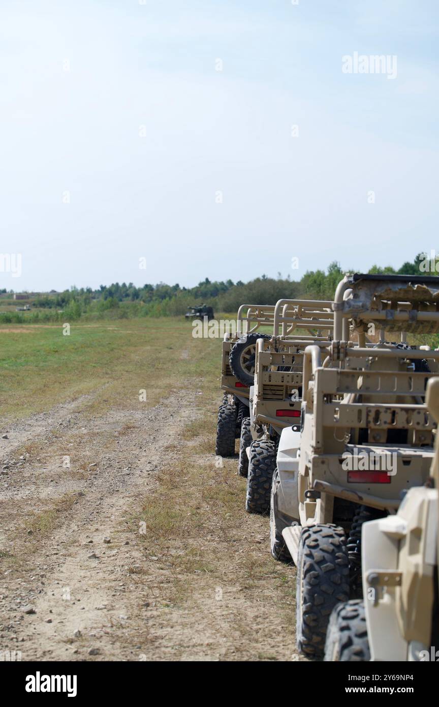 An ATV convoy awaits a Joint Terminal Attack Controller team from the ...