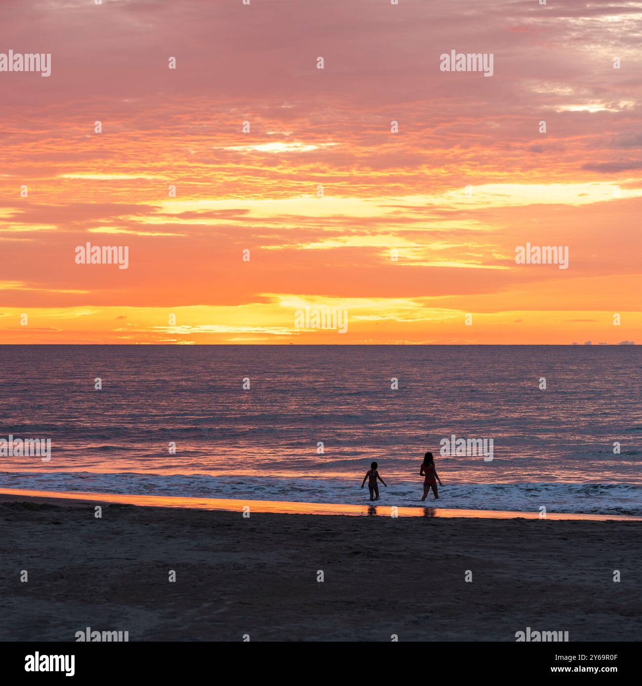 Silhouettes of people going to swim in the Pacific Ocean, Ecuador Stock ...