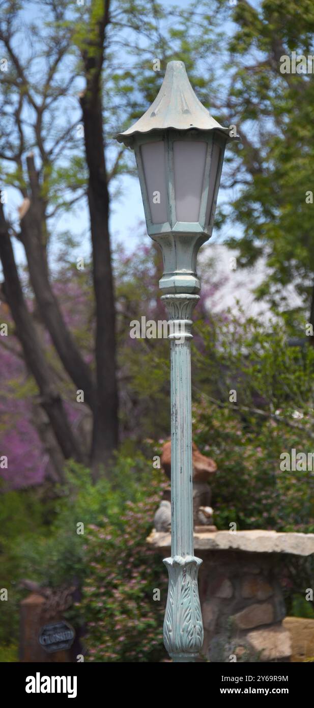Beautiful, green metal, lamp post stands in a garden in New Mexico ...