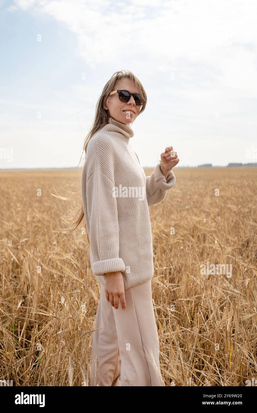 A Chic Model Dressed in a Stylish Sweater and Sunglasses Poses ...