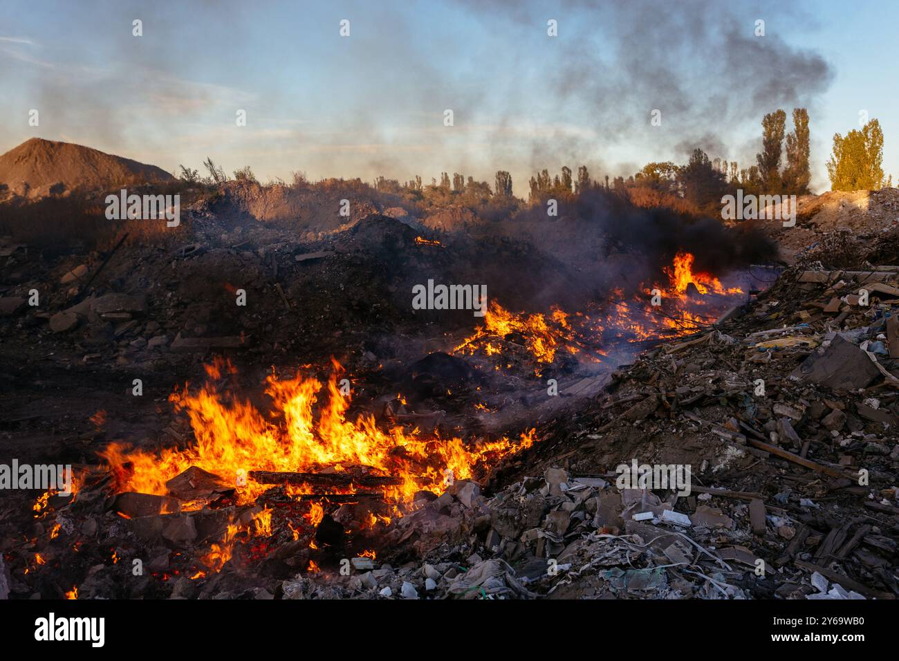 Burning garbage at landfill. Air pollution concept Stock Photo - Alamy