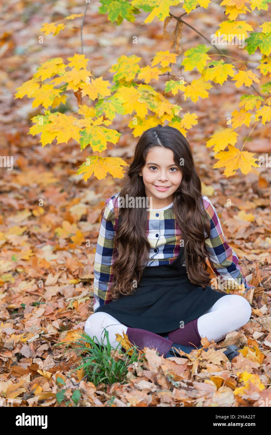 Back to school. Autumn leaves. Girl in fall park wear uniform. Teen ...