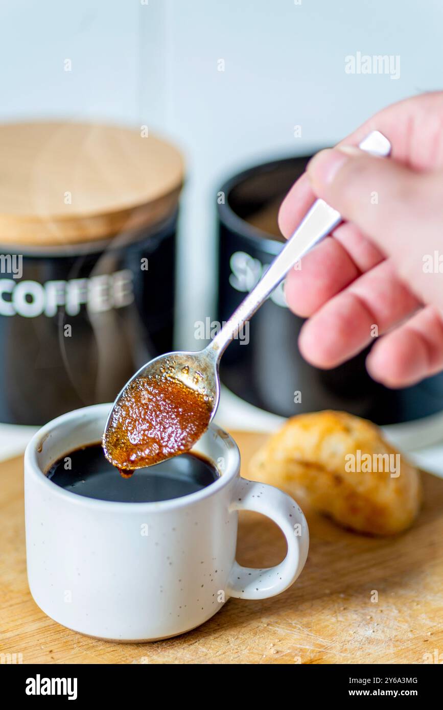 Grains of brown sugar draw up the hot coffee,making into a syrupy ...