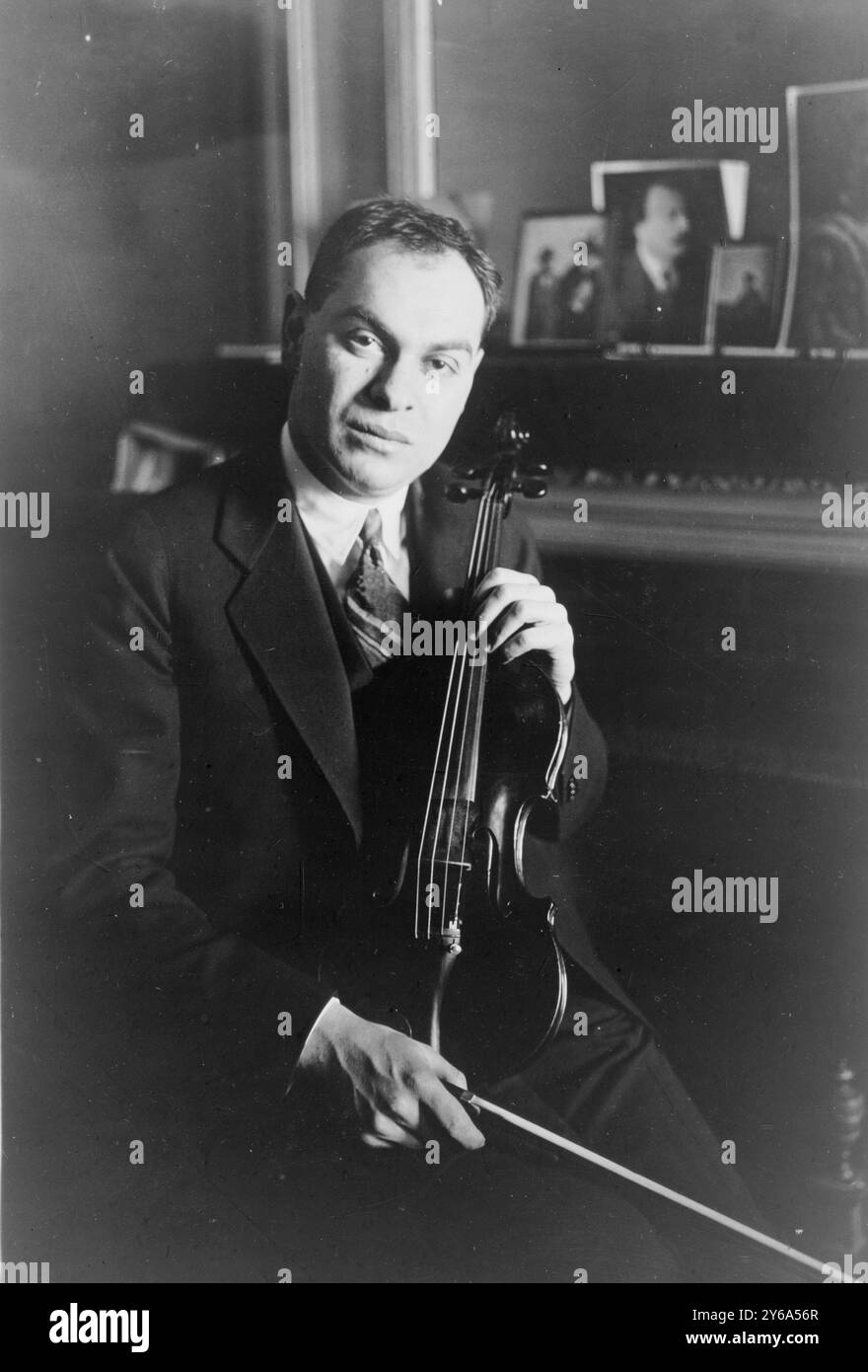 Eddy Brown, half-length portrait, seated, holding his violin, between ...