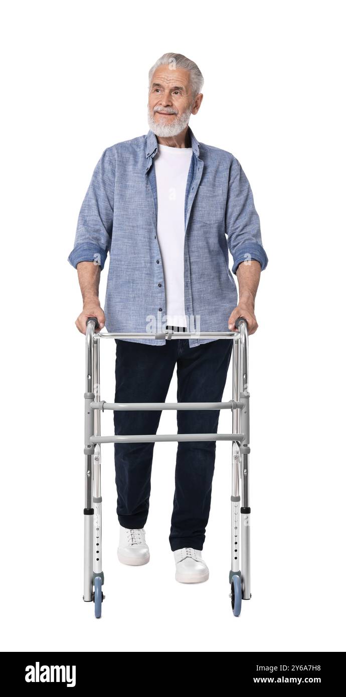 Senior man using walking frame on white background Stock Photo - Alamy