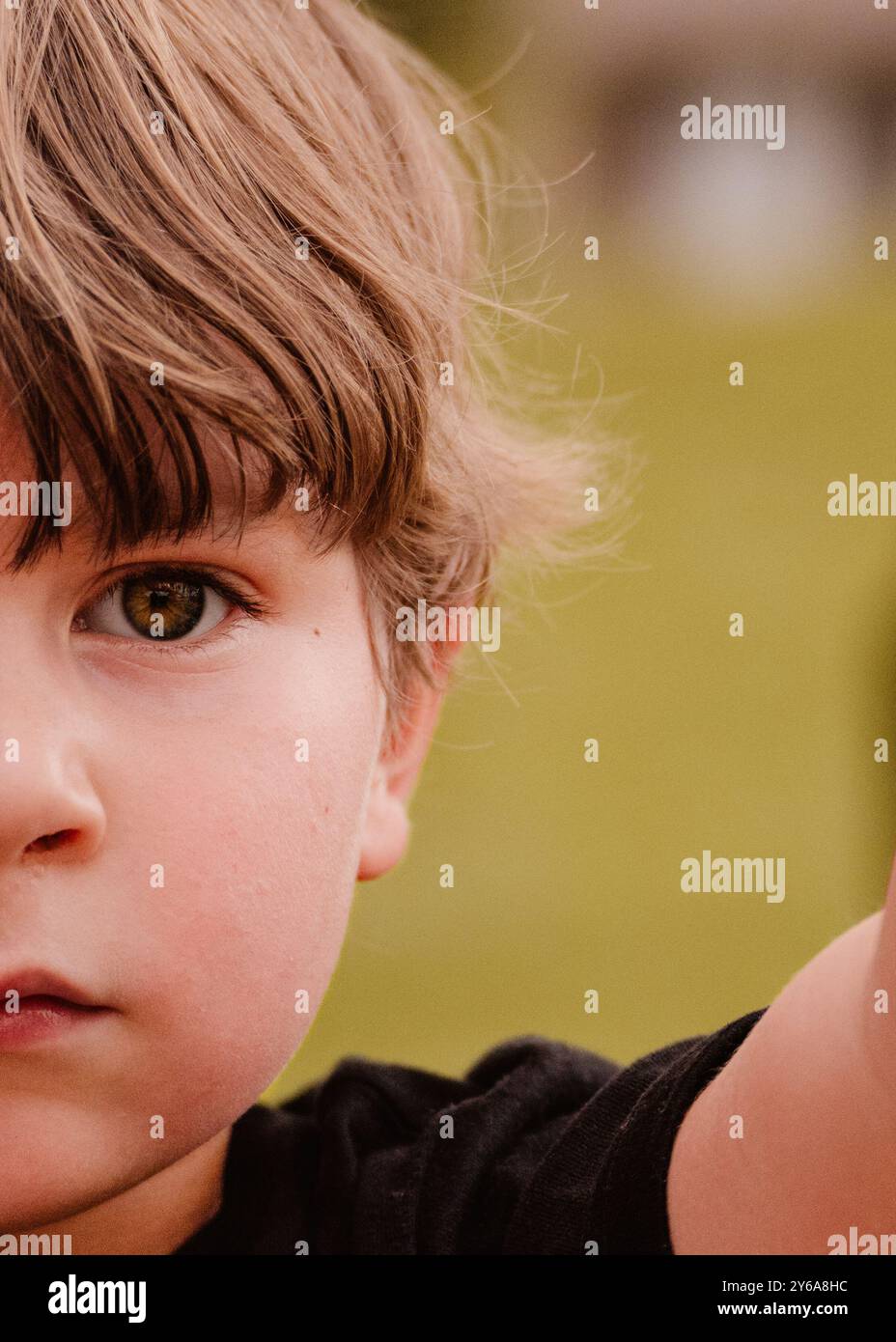young child boy face with colorful eye outside Stock Photo - Alamy