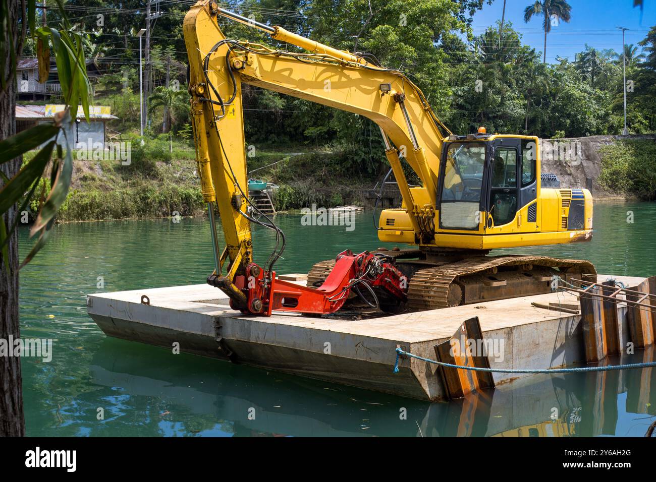Excavator on a floating platform, cleaning and deepening the river ...
