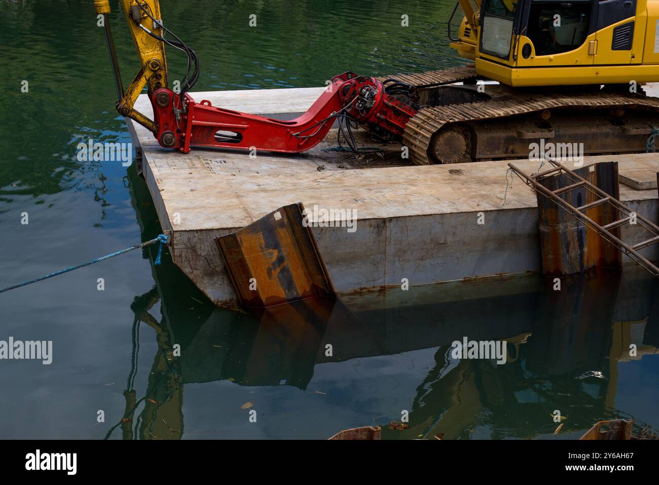 Excavator on a floating platform, cleaning and deepening the river ...