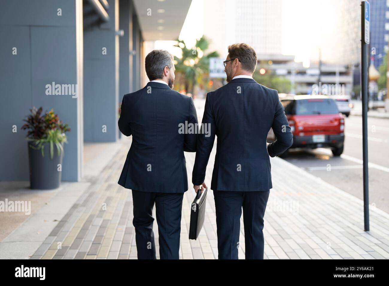 Business men talking. Walking and talking two business men. Colleague ...