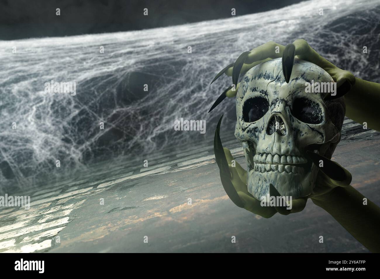 Witch hand with long nail claws holding a human head skull. The color ...