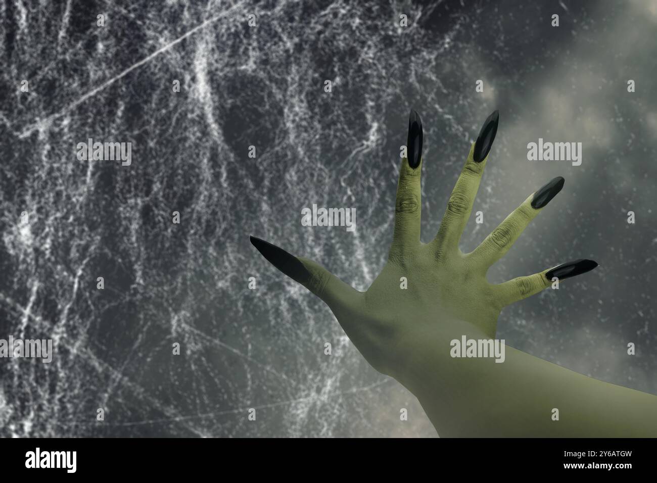 Witches hand with long nail claw. The color is green. Evil, zombie, or ...