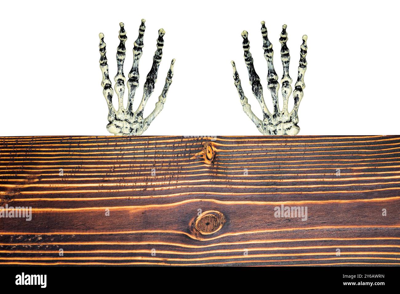 Two human skeletons hands are peeking out from behind a wooden board on ...