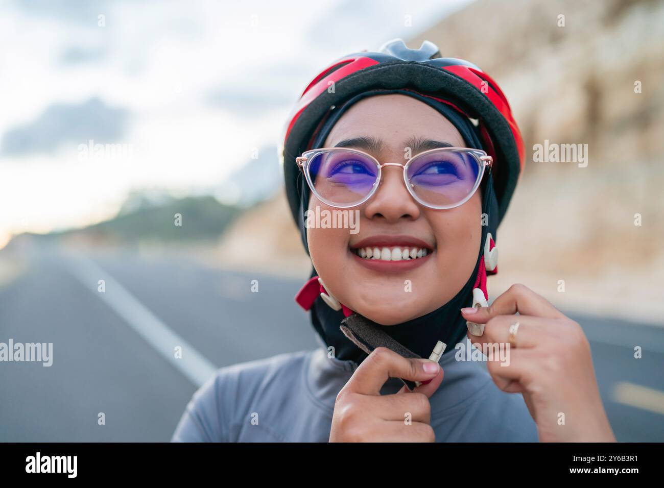 hijab biker putting on helmet for safety riding bike Stock Photo - Alamy