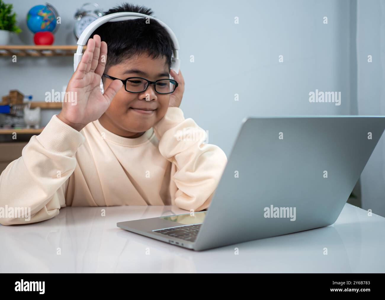 Little Asian boy student using computer laptop learning. Educational of ...