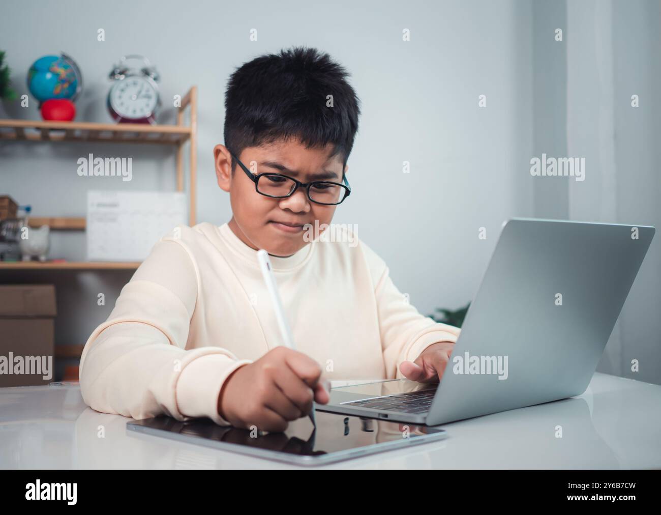 Little Asian boy student using computer laptop learning. Educational of ...