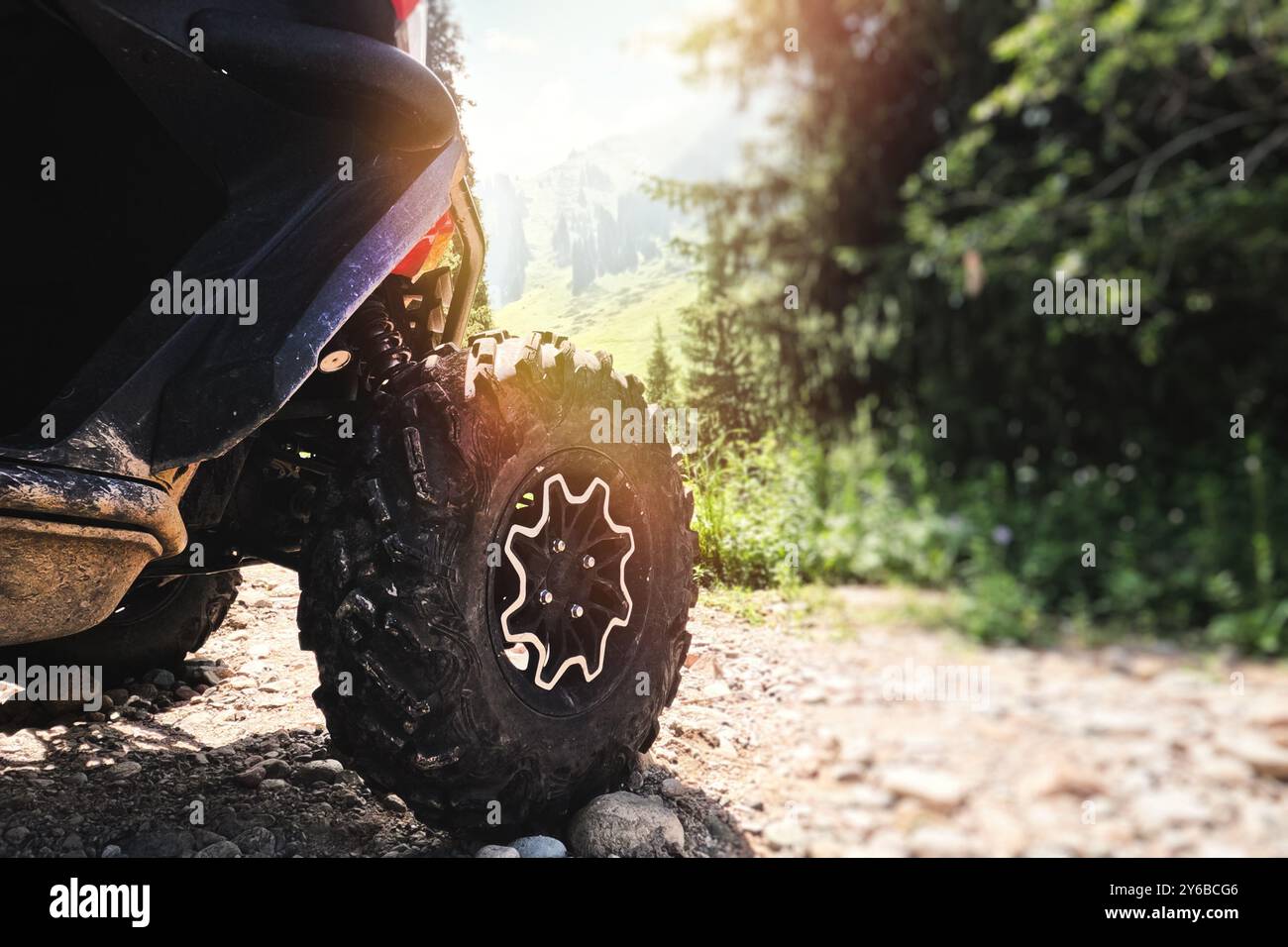 Big aggressive ATV off-road quad bike wheel against a picturesque ...