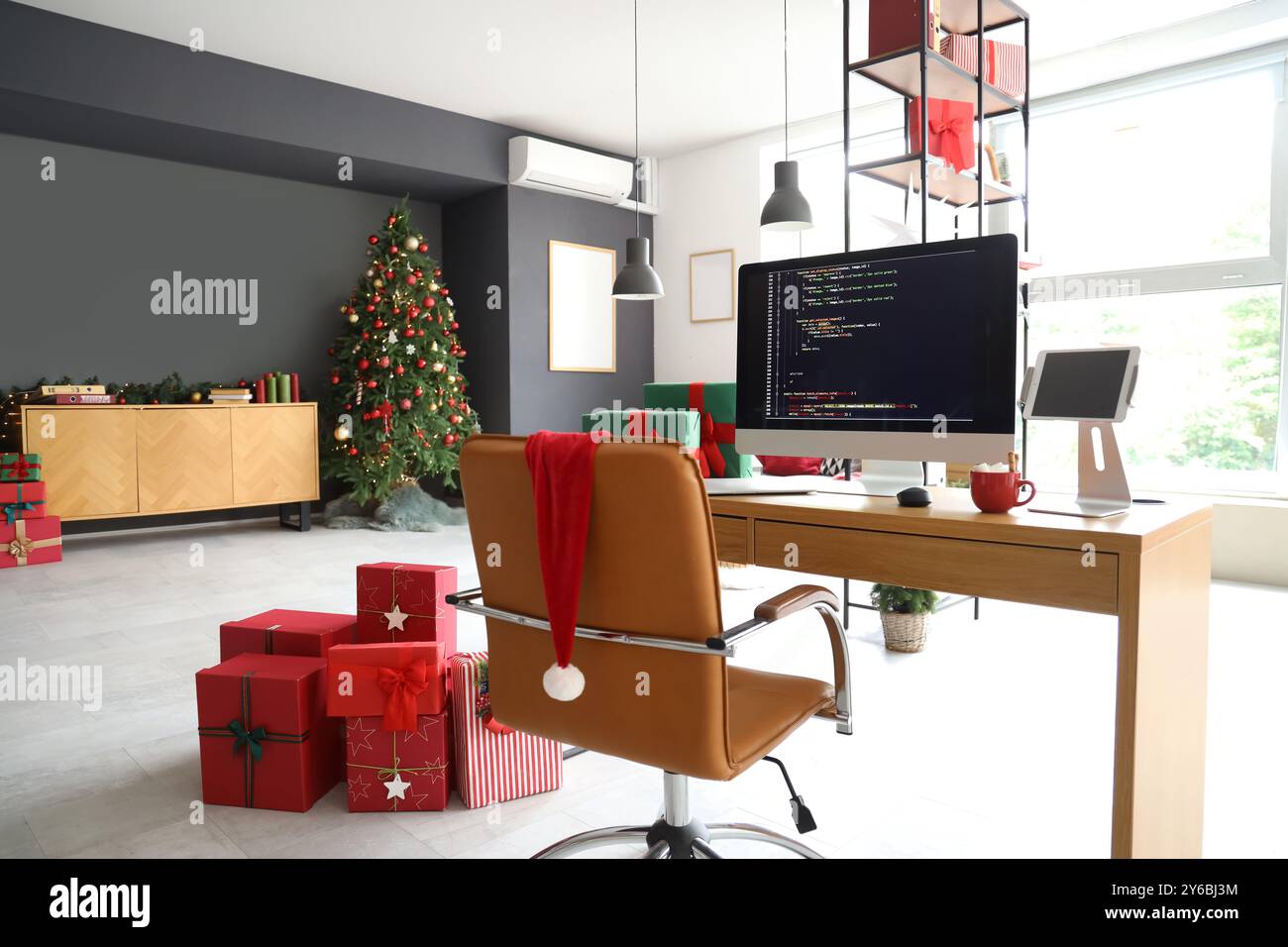 Interior of office with programmer's workplace decorated for Christmas ...