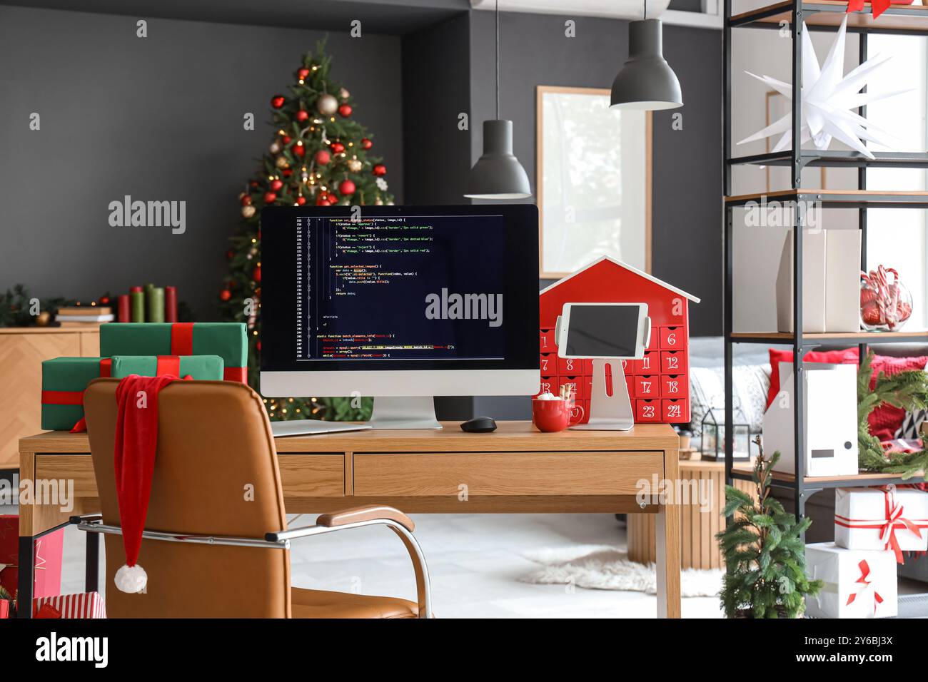 Interior of office with programmer's workplace decorated for Christmas ...