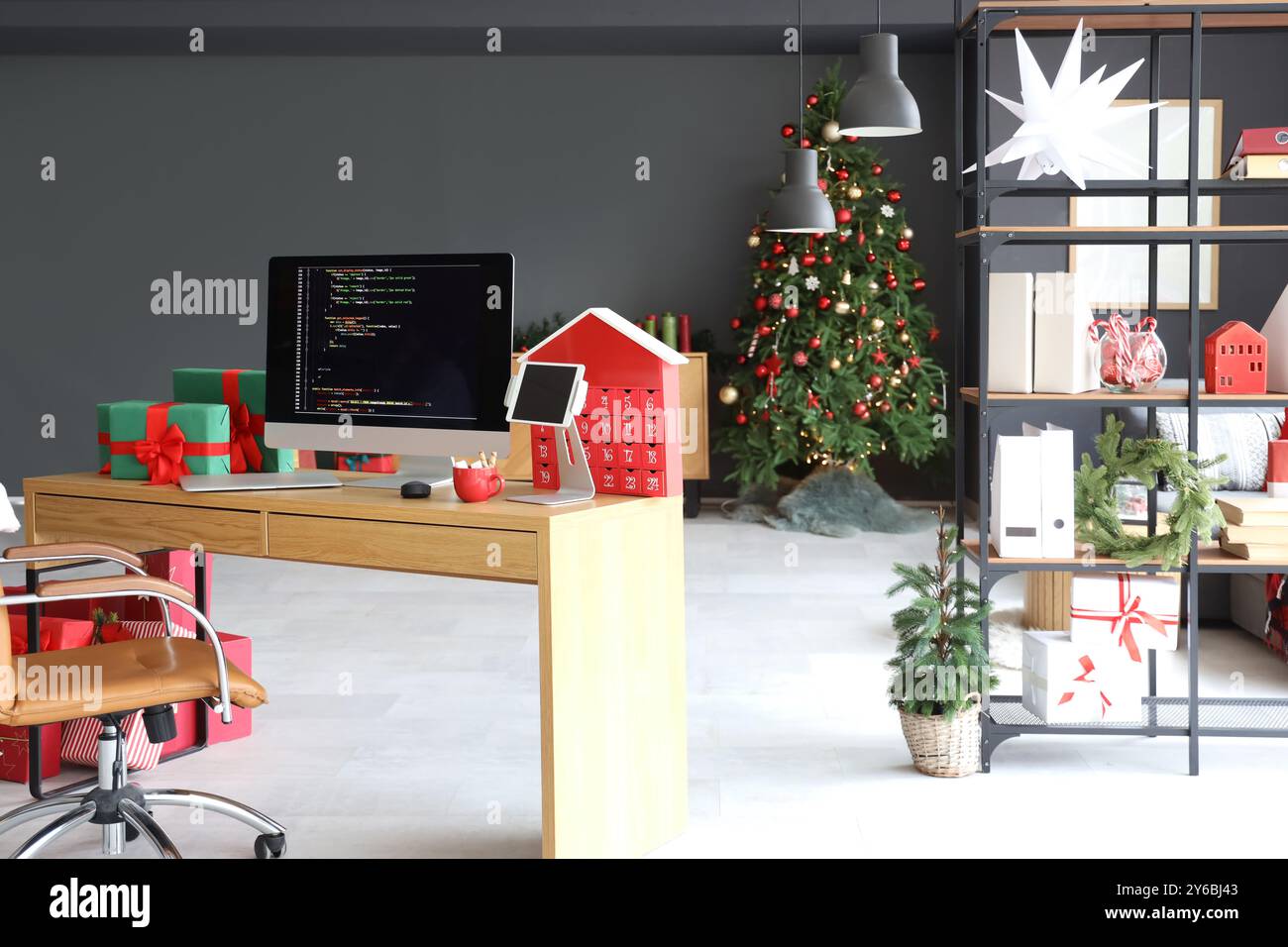 Interior of office with programmer's workplace decorated for Christmas ...