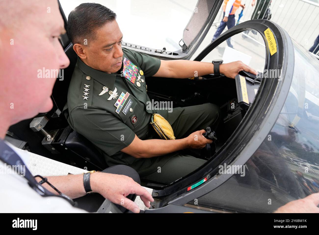 Philippine military chief Gen. Romeo Brawner Jr. right, sits inside the ...