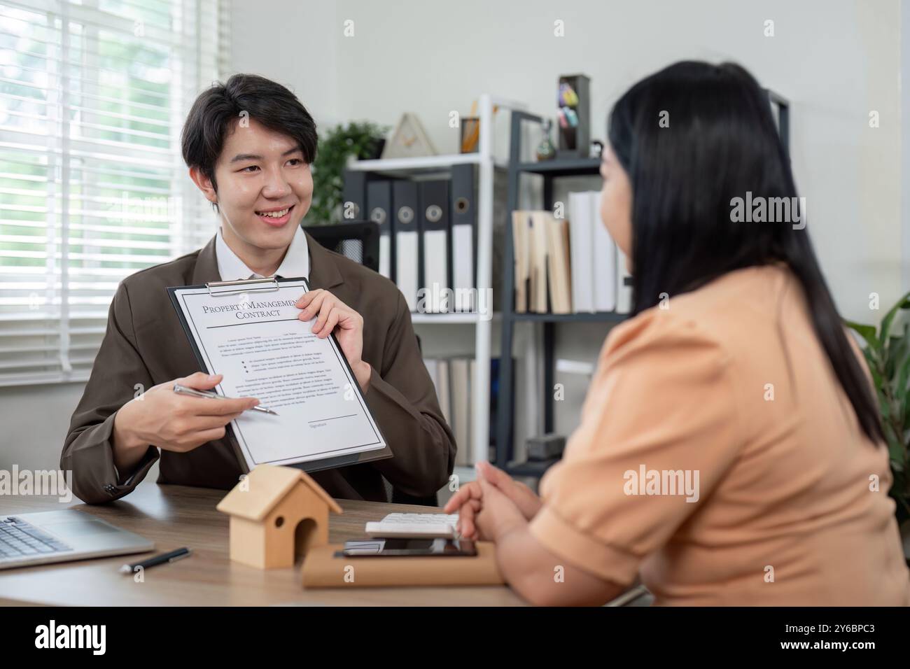 Real Estate Agent Explaining Property Contract to Engaged Client for ...