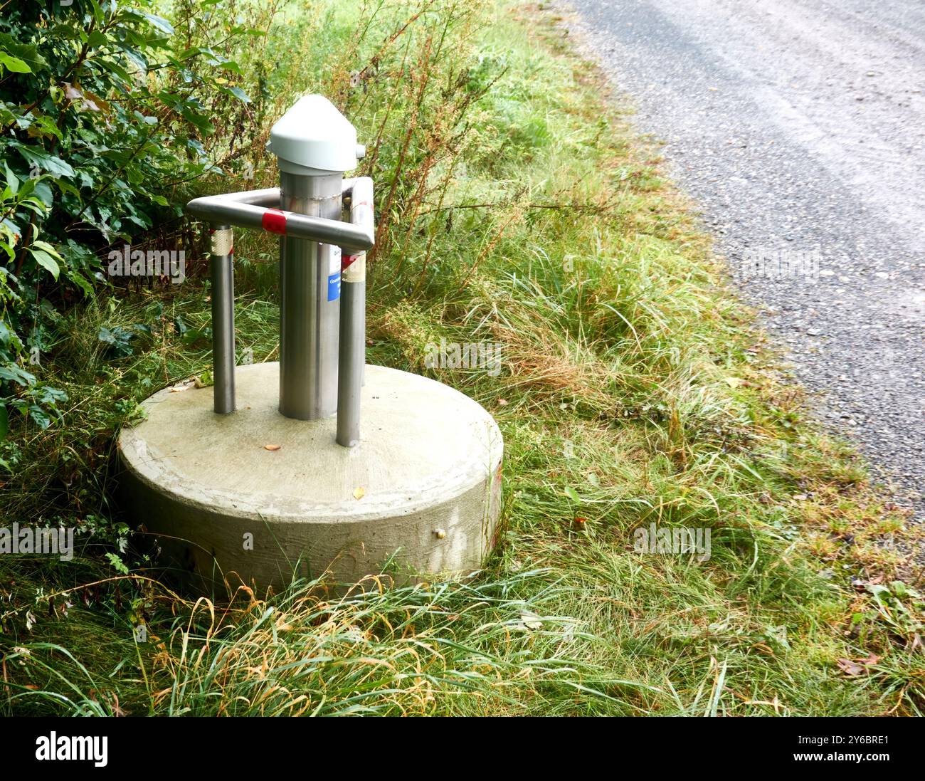 groundwater monitoring station in concrete base with protective ...