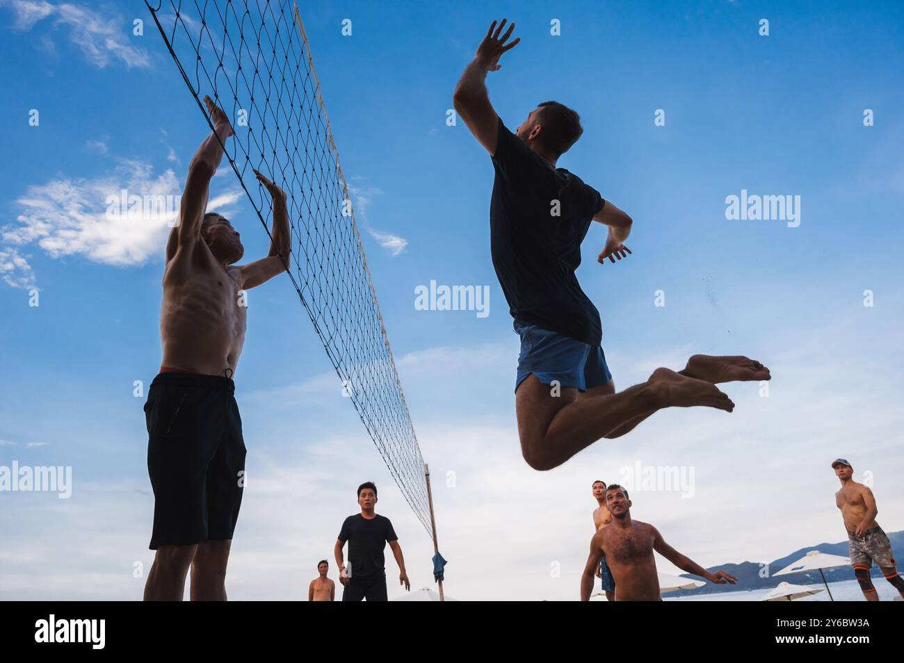 Teams with multinational players play beach volleyball on the beach in ...