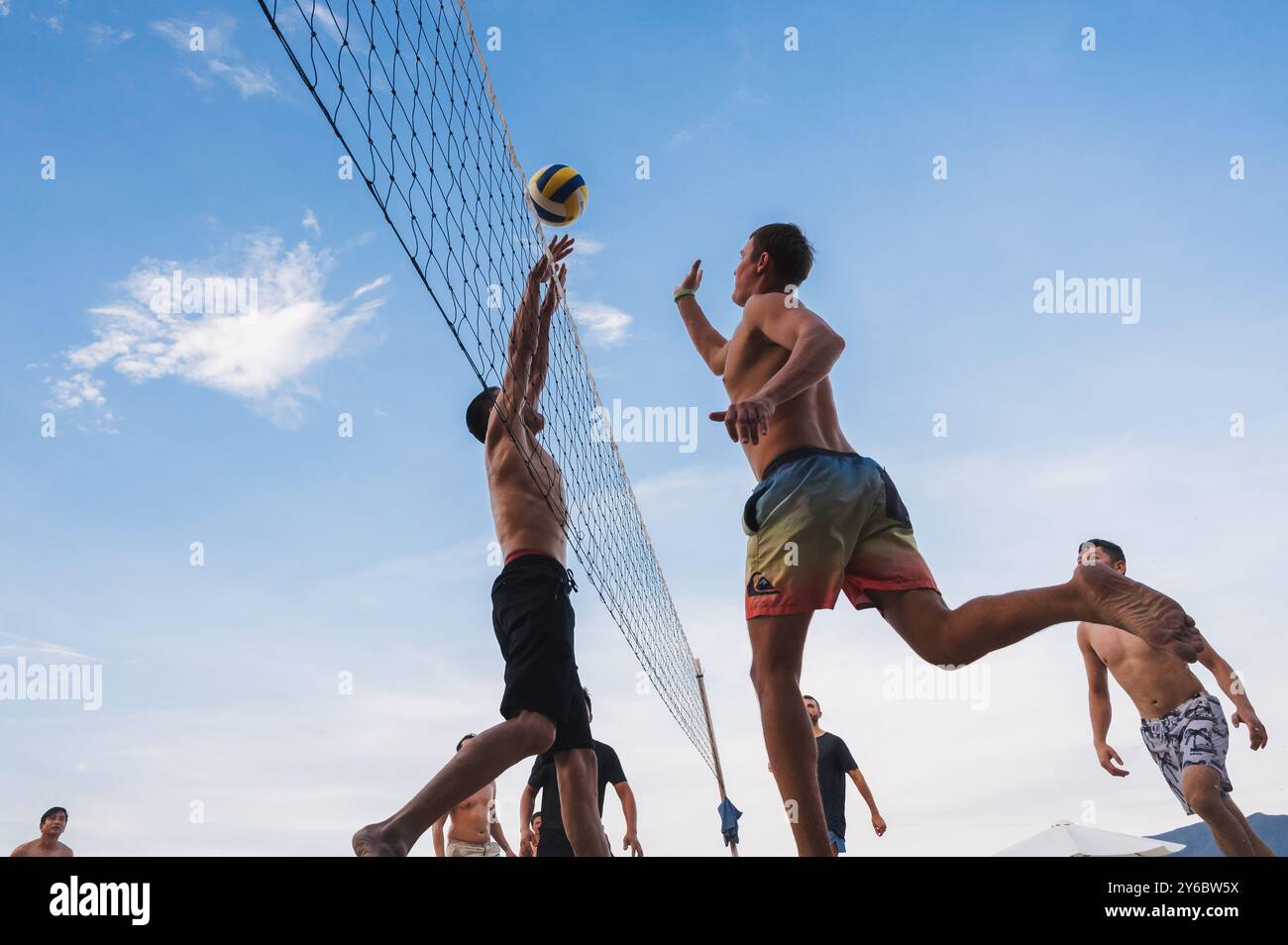 Teams with multinational players play beach volleyball on the beach in ...