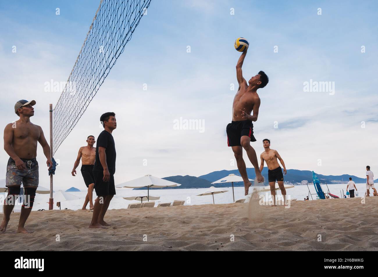 Teams with multinational players play beach volleyball on the beach by ...