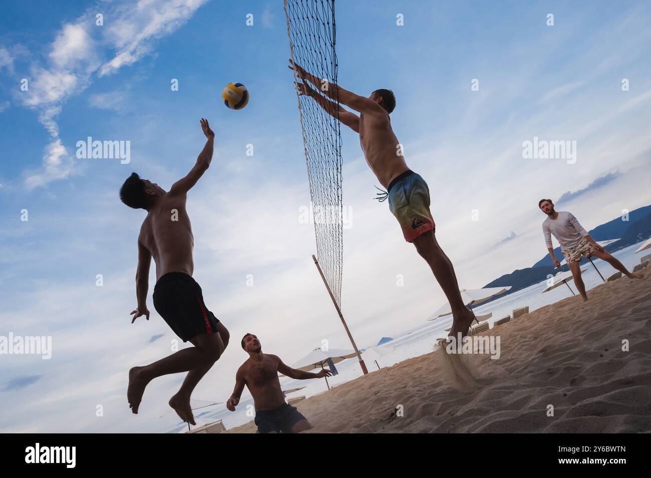 Teams with multinational players play beach volleyball on the beach by ...