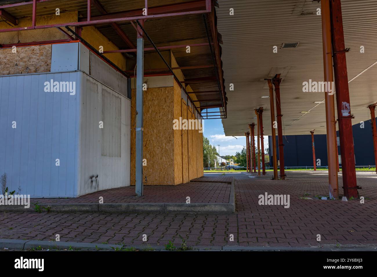 Inactive and abandoned gas station, inactive dispensers, boarded up ...